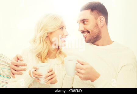 Happy family with cups of hot tea spending time together in winter ...