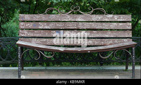 Park bench, with inscriptions of lovers Stock Photo - Alamy
