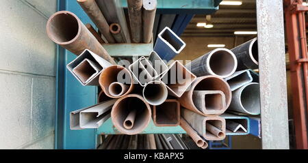 Various lengths and offcuts of steel waiting in the steel rack for use ...
