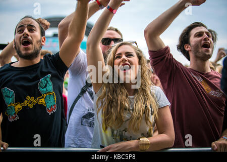 Enthusiastic and energetic music fans and festival Goers enjoy a live ...