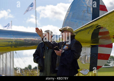 Pilot and warbird owner Stephen Grey making a flying plane hand motion ...