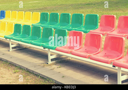 Multicolored benches for sports fans standing in two rows Stock Photo ...