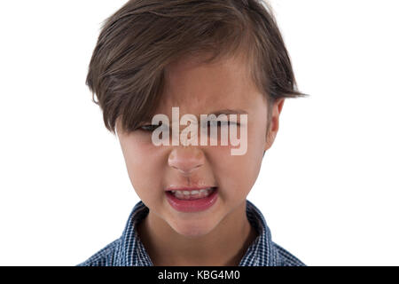 Portrait of frustrated boy standing against white background Stock ...