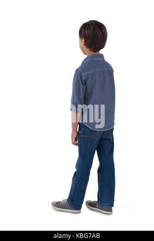 Thoughtful boy standing against white background Stock Photo - Alamy