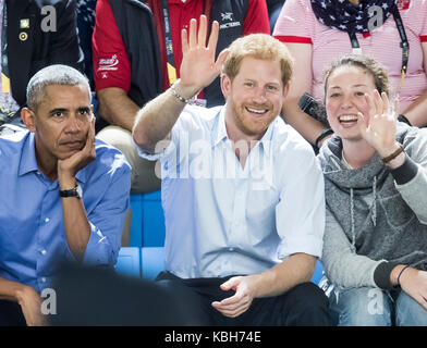 Barack Obama and Prince Harry are pictured with spectator Hayley Stover ...