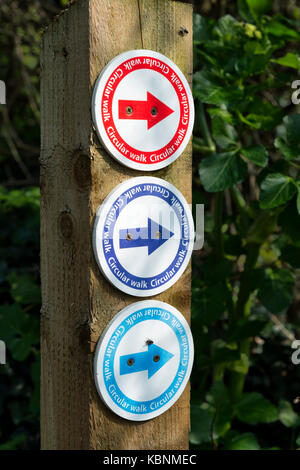 Wooden post with two circular signs showing the direction of public ...