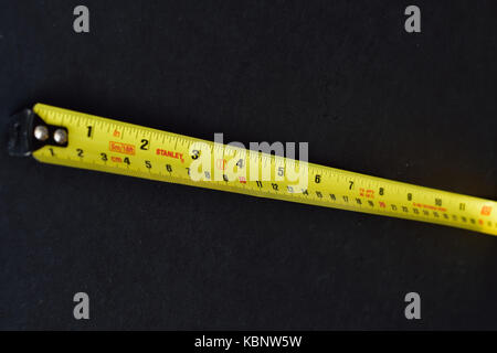 Yellow Stanley steel tape measure on black background Stock Photo - Alamy