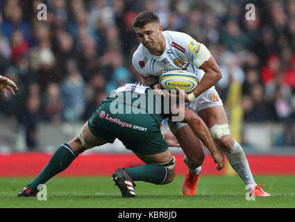 Exeter Chiefs' Henry Slade is tackled by Leicester Tigers' Samuel ...