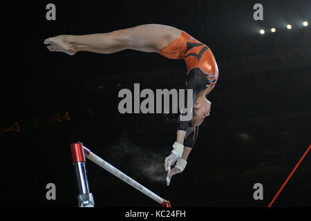 Fan Yilin, of China, performs in the uneven bars event of the women's ...