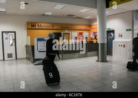 London Luton Airport, UK, check-in hall. Wizz Air passengers queue to ...