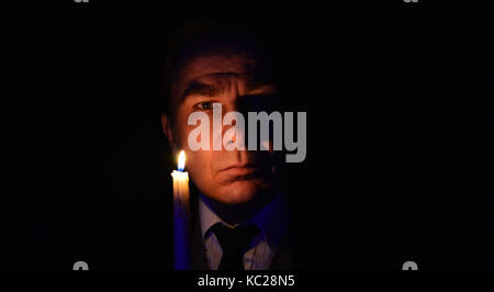 Butler with candle Stock Photo - Alamy
