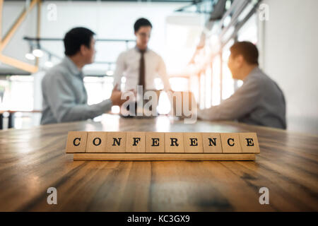 Conference word on wood table with Business team work discussion ...