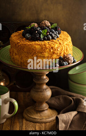 Homemade layered honey cake with cream and red raspberries Stock Photo ...