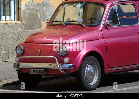 Pink purple Fiat 500 parked on the street. Classic vintage model ...