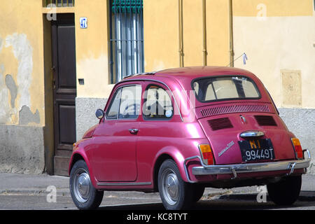 Pink purple Fiat 500 parked on the street. Classic vintage model ...
