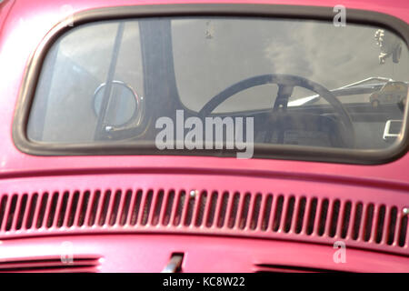 Pink purple Fiat 500 parked on the street. Classic vintage model ...