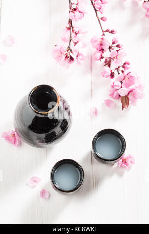 Strong Japanese sake with blooming pink flowers. Traditional high ...