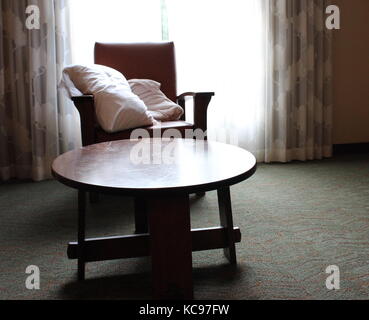 Chair with Pillow and Folded Sheets Stock Photo - Alamy
