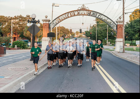 Law enforcement academy cadets running in formation through the streets ...