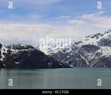 A scenic view of Alaska Fjord with rocky mountains range with misty ...