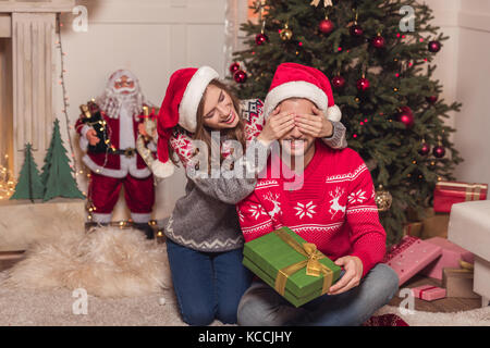 Gift or present box, party hats and stars on white table. Christmas ...
