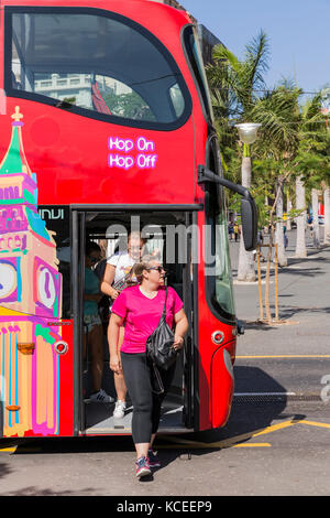 Tourists passengers open top sightseeing double decker tour bus & green ...