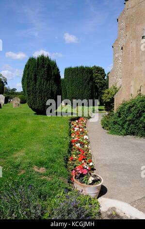 A view of the churchyard of St Peter and St Paul in the village of ...