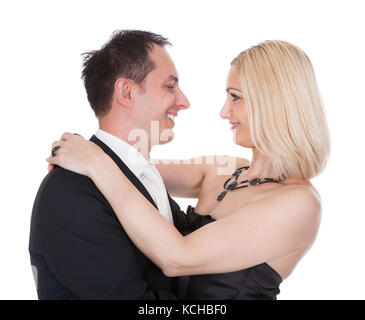 Young couple standing over isolated background showing arms muscles ...