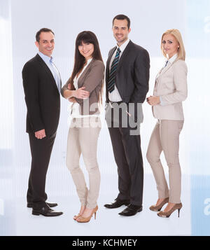 Diverse group of coworkers standing together beside a truck in a ...