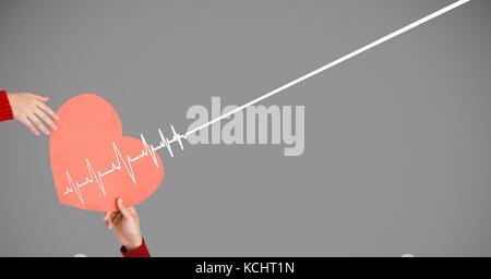 Digital composite of Heart beat over hands holding heart Stock Photo ...