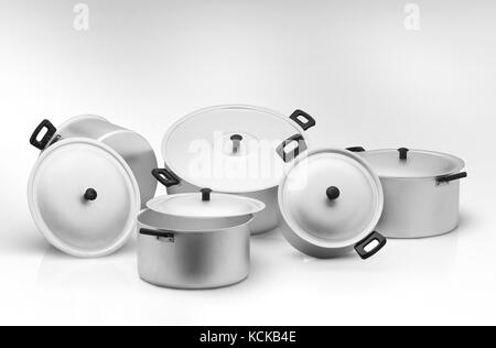 several cooking pots on a light background Stock Photo - Alamy