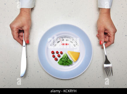 hands with kitchen flatware and healthy food in plate Stock Photo - Alamy