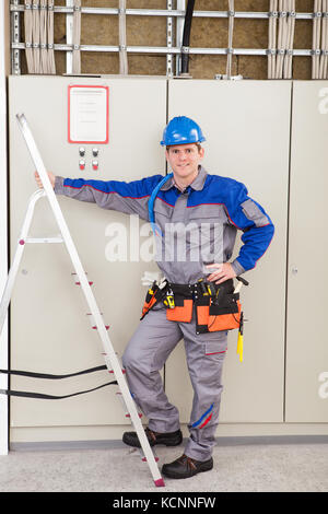 Male Repairman Leaning On Ladder Over White Background Stock Photo - Alamy