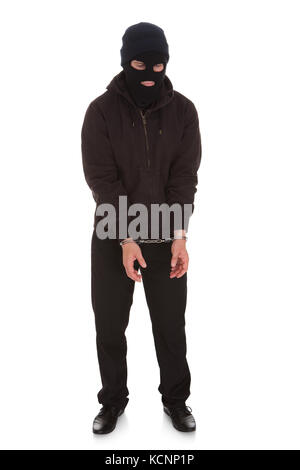 Angry Criminal Locked In Handcuffs Over White Background Stock Photo ...