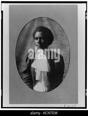 A portrait of a woman facing left, capturing a moment of serenity. The ...