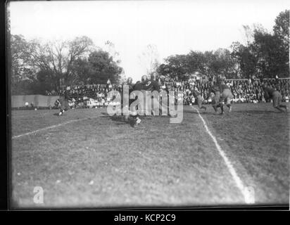 The 1922 Miami-Akron football game captures a moment of intense action ...