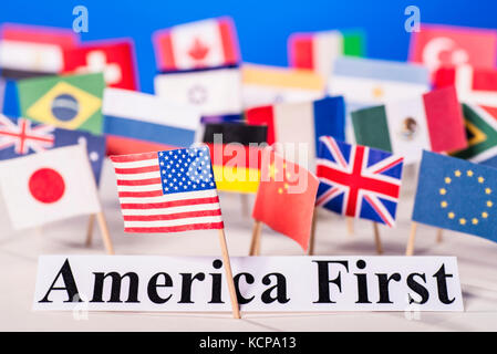 American flag is in front of the slogan America First and many flags ...