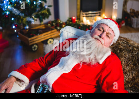 Santa claus sleeping on the couch Stock Photo - Alamy