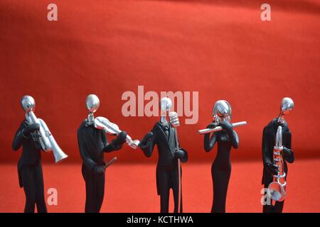 Toy man with microphone and musicians on the red background Stock Photo ...