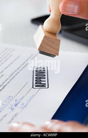 Approved stamp on the document, signature of businessman and consent ...