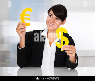 Businesswoman with euro currency sign Stock Photo - Alamy