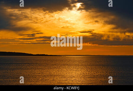 Canada, Nova Scotia, Fox Island. Sunset on rocky shoreline of ...