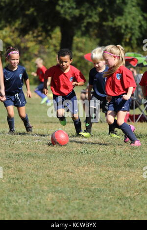 Children running after soccer ball. Front view of young boys in ...