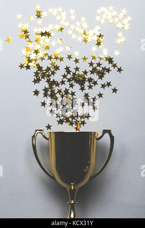 Gold winners trophy with golden shiny stars Stock Photo - Alamy