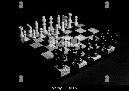 Low light photo of chess pieces and board Stock Photo - Alamy