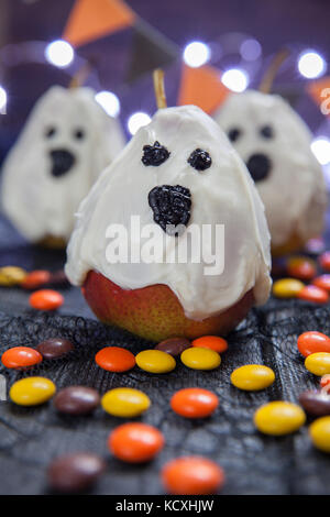 Three homemade creative Halloween candy pears or white chocolate ghosts ...