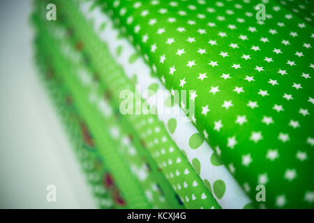 Stack of fabric green cloth rolls Stock Photo - Alamy