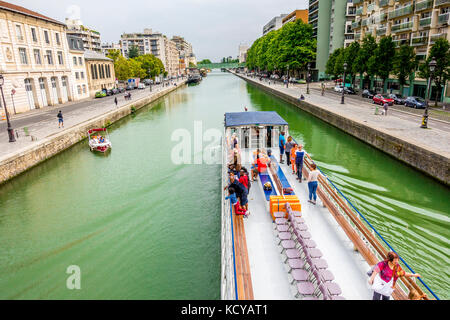 A River cruise boats leaving the Bassin de la Villette after going ...