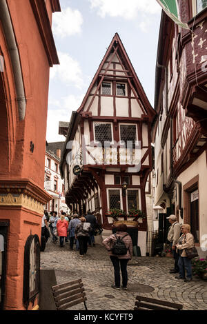 A narrow street in Germany shows historic buildings with half-timbered ...