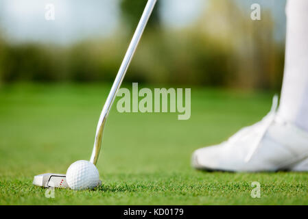 Male golfer making a putt Stock Photo - Alamy